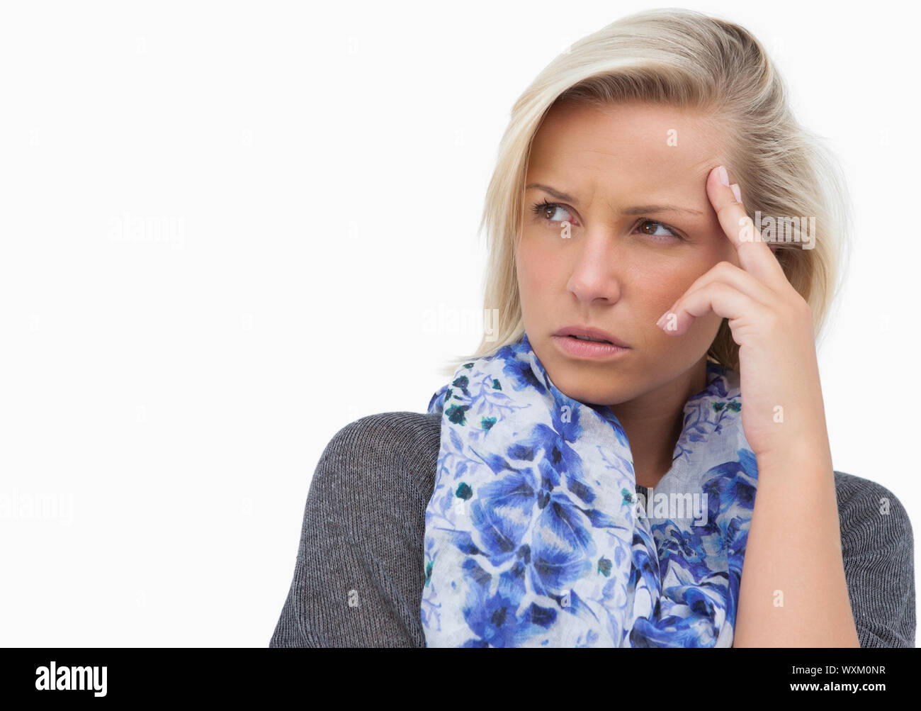 Anxious blonde looking away on white background Stock Photo - Alamy