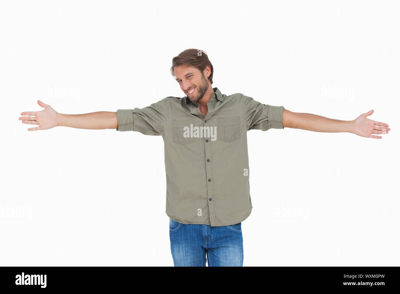 Man standing with arms outstretched on white background Stock Photo - Alamy