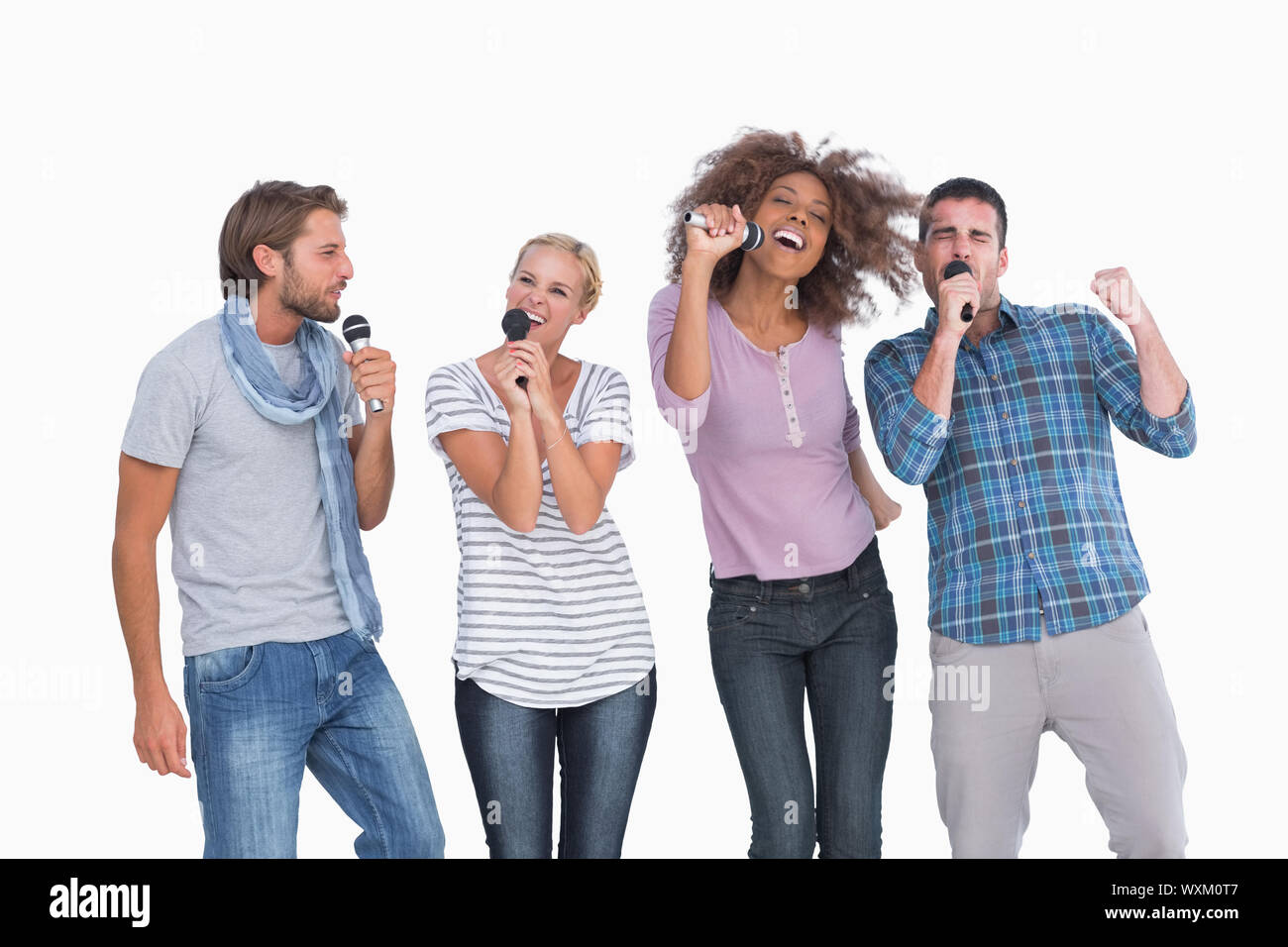 Fun group singing at karaoke on white background Stock Photo - Alamy