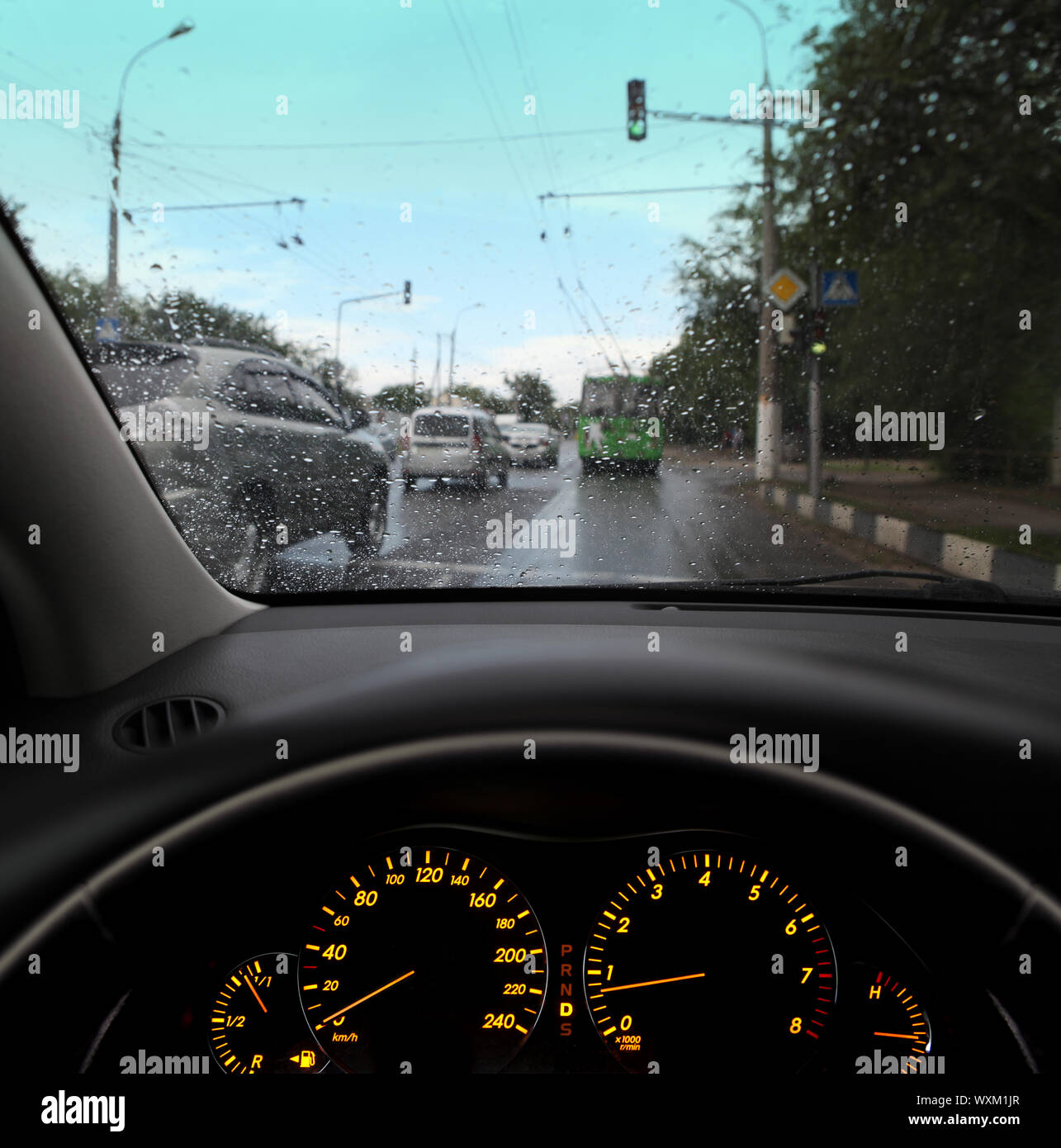 rain droplets on car windshield, traffic in city Stock Photo - Alamy
