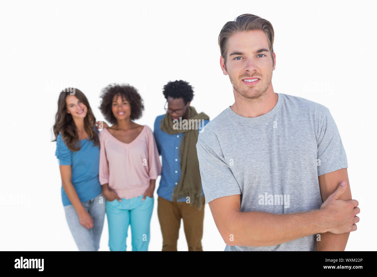 Handsome man gesturing in front of group of people against white ...