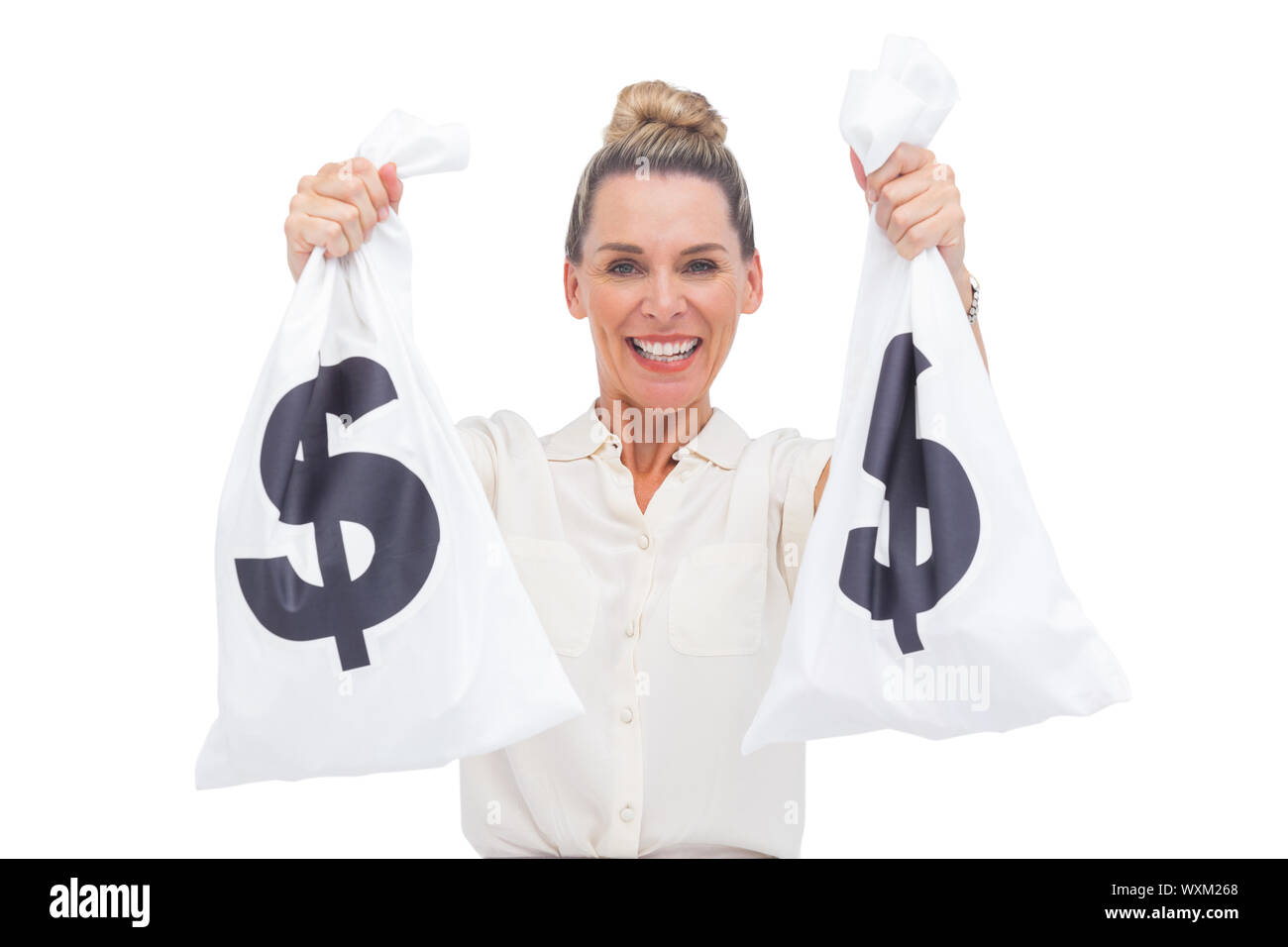 Cheerful businesswoman carrying cash bags on white background Stock ...