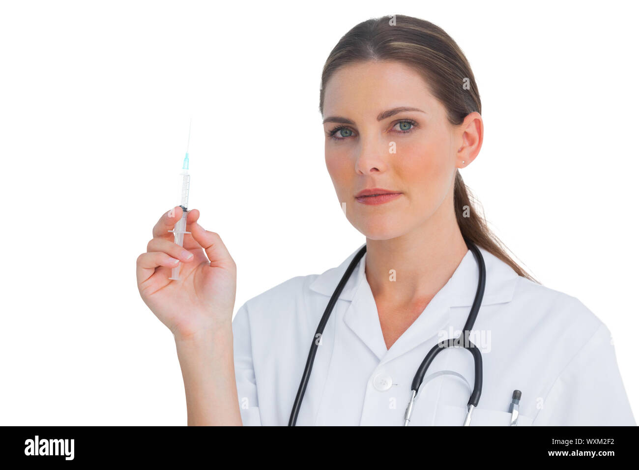 Stern nurse holding a syringe on white background Stock Photo - Alamy
