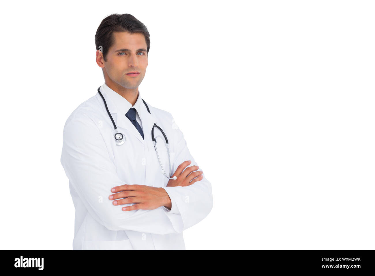 Stern doctor with arms crossed on white background Stock Photo - Alamy