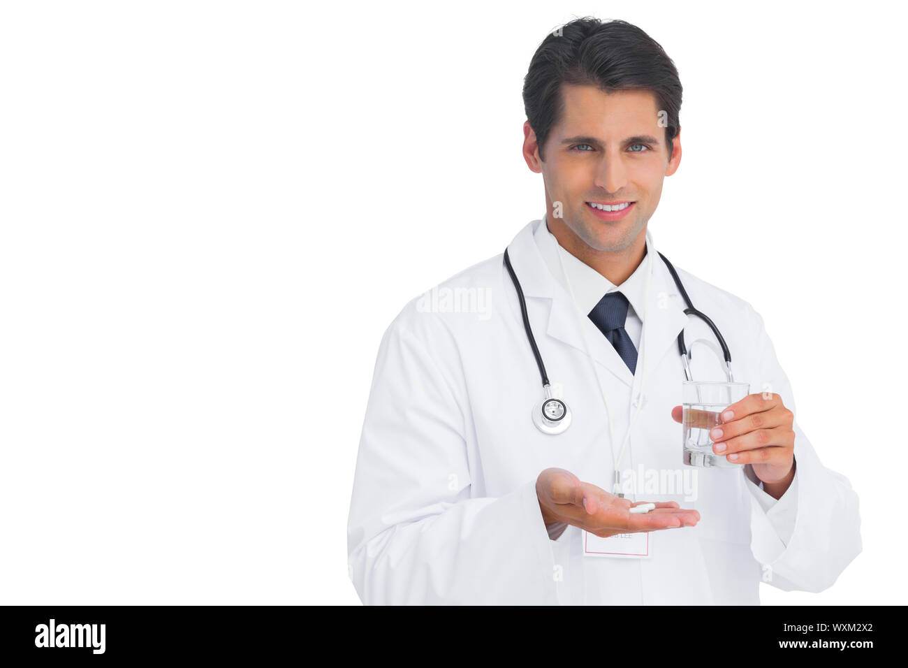 Happy doctor smiling and holding medicine on white background Stock ...