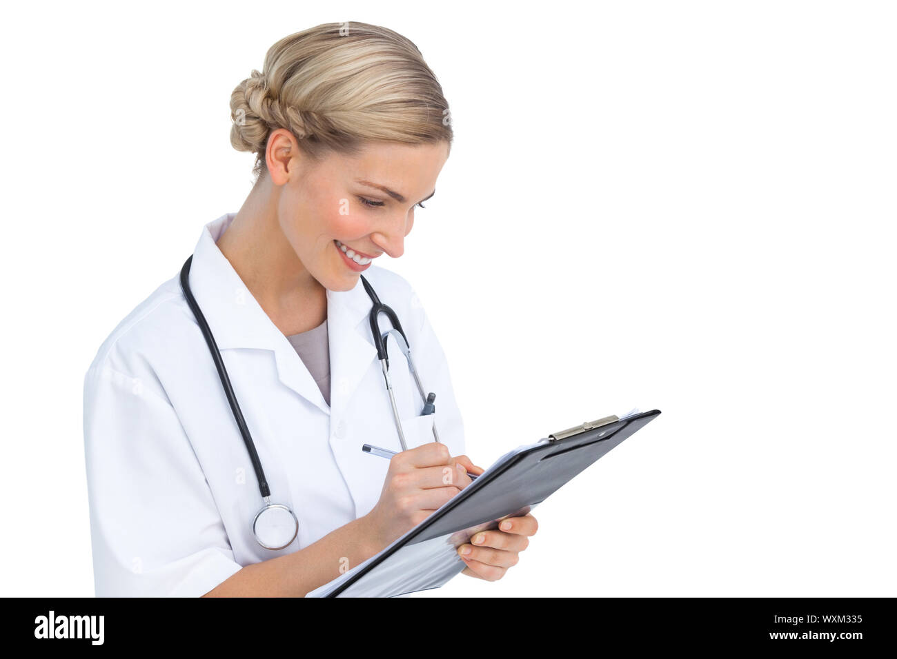 Smiling nurse writing on clipboard with a pen Stock Photo - Alamy
