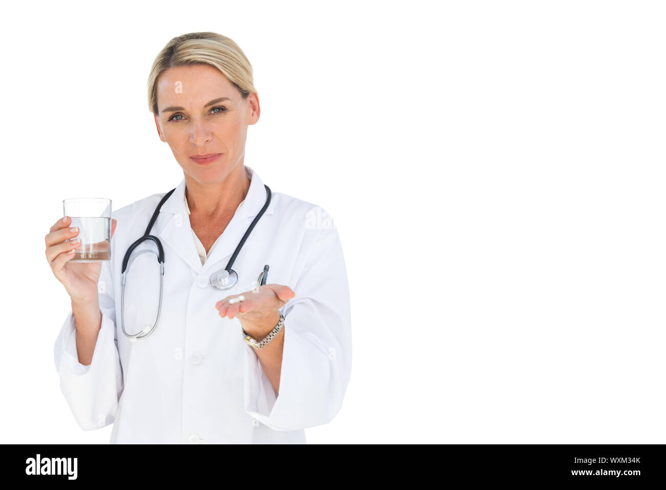 Happy doctor holding out drugs and water glass on white background ...