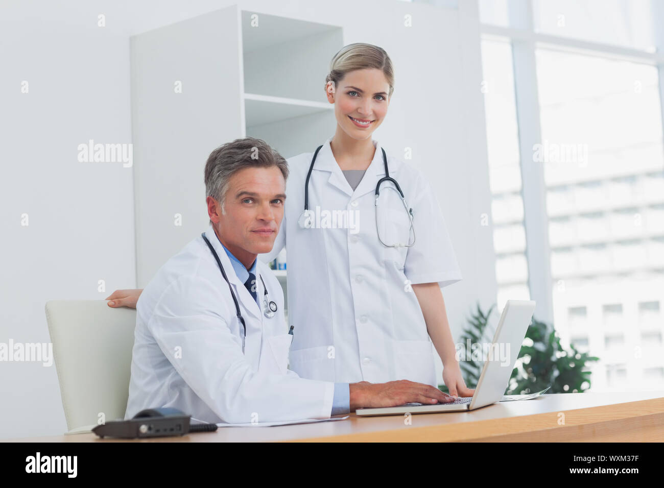 Medical team smiling at the office Stock Photo - Alamy