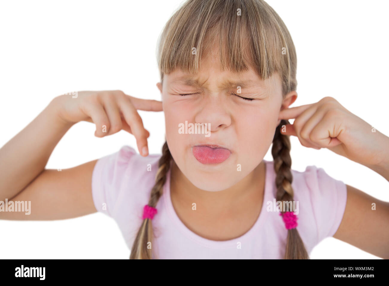 Little girl clogging her ears on white background Stock Photo - Alamy