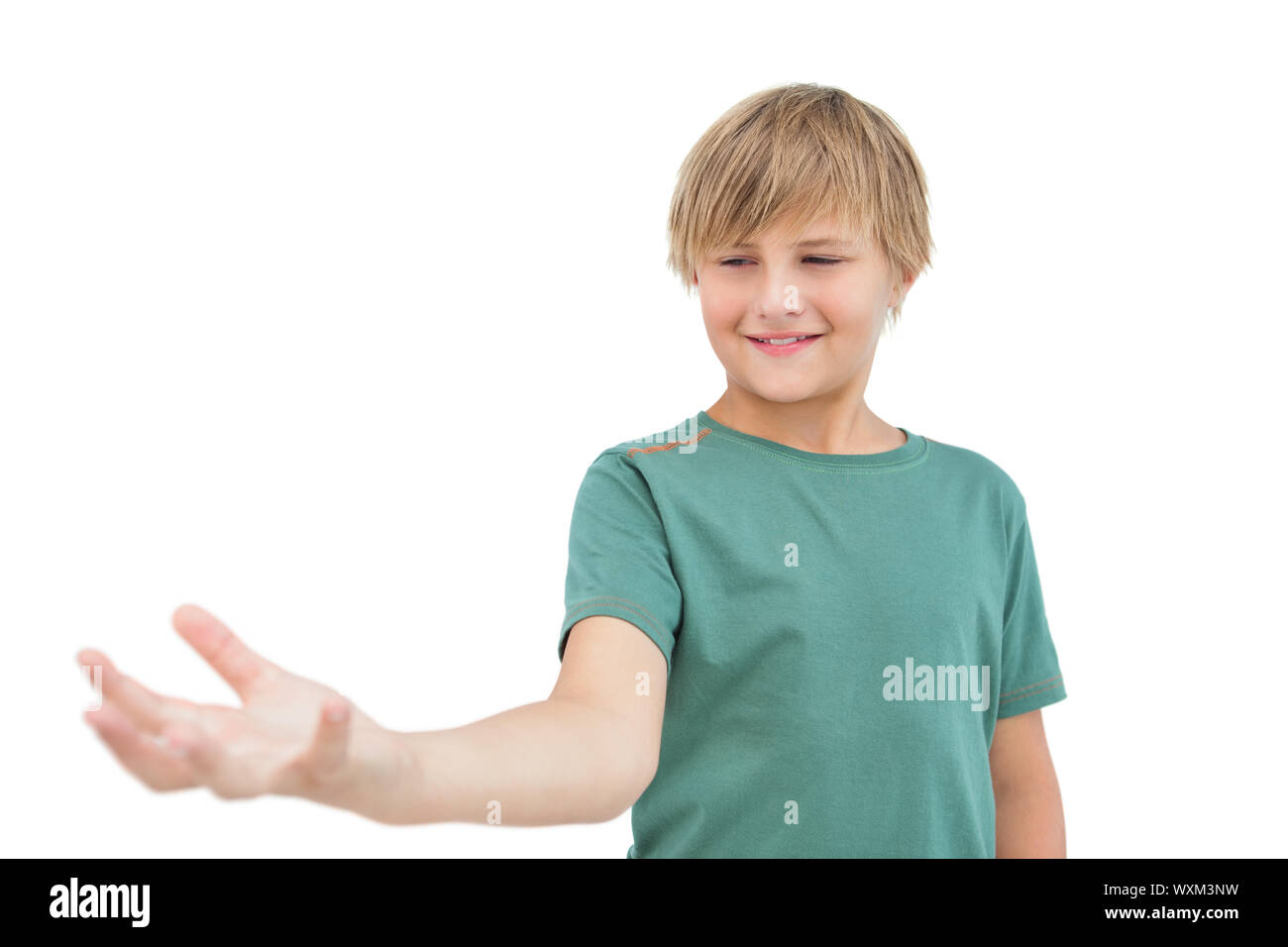 Smiling little boy holding something on white background Stock Photo ...