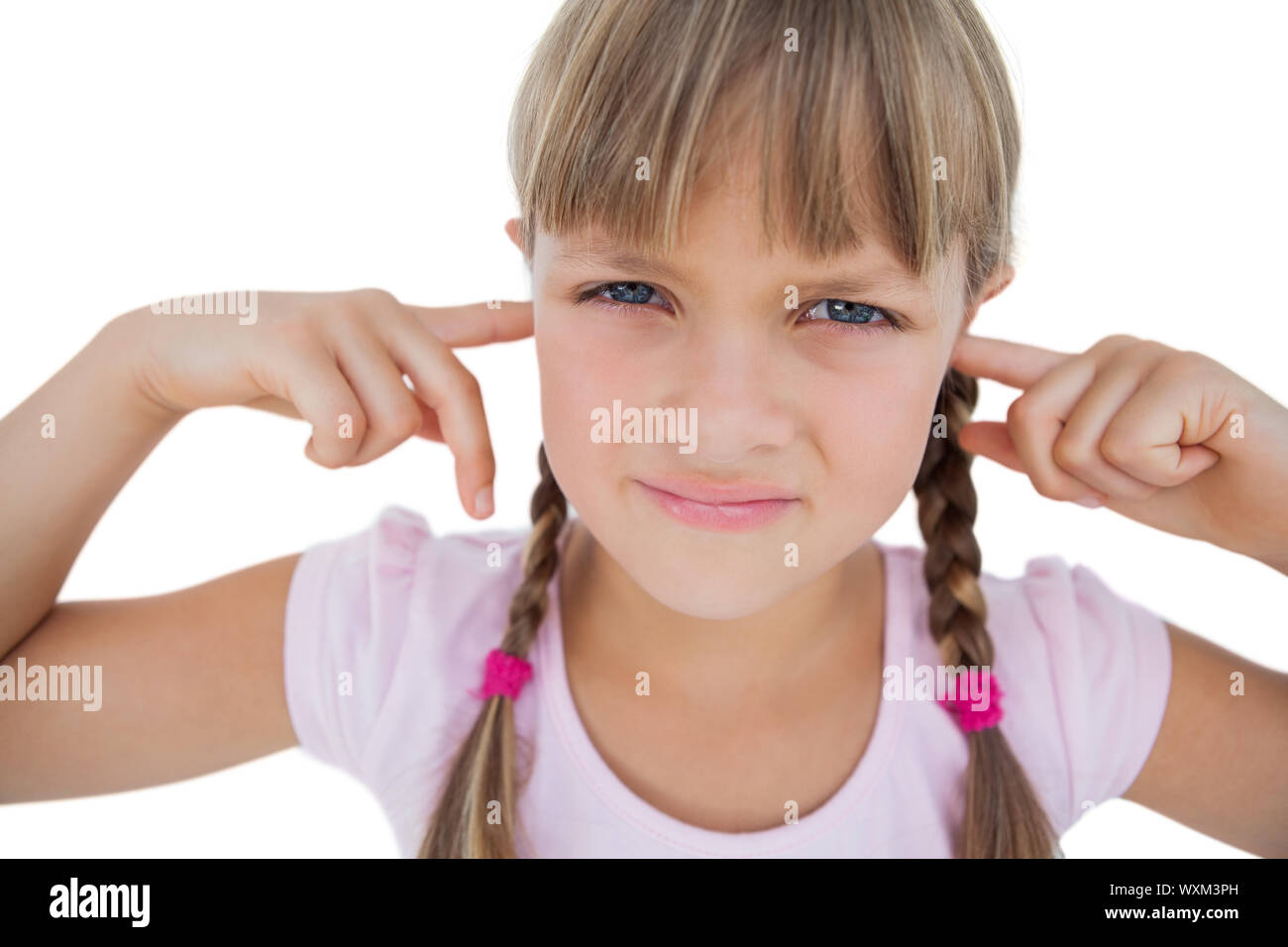 Little girl clogging her ears on white background Stock Photo - Alamy