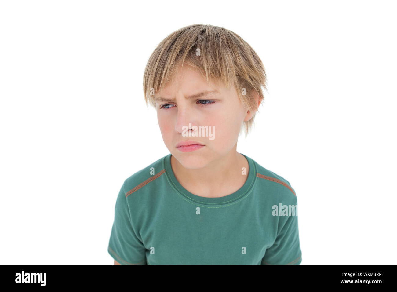 Furious little boy looking down on white background Stock Photo - Alamy