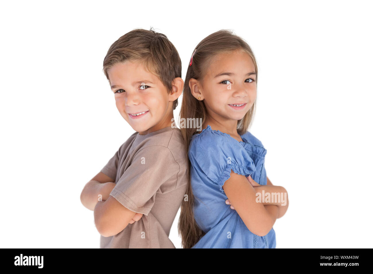 Children standing back to back with arms crossed on white background ...