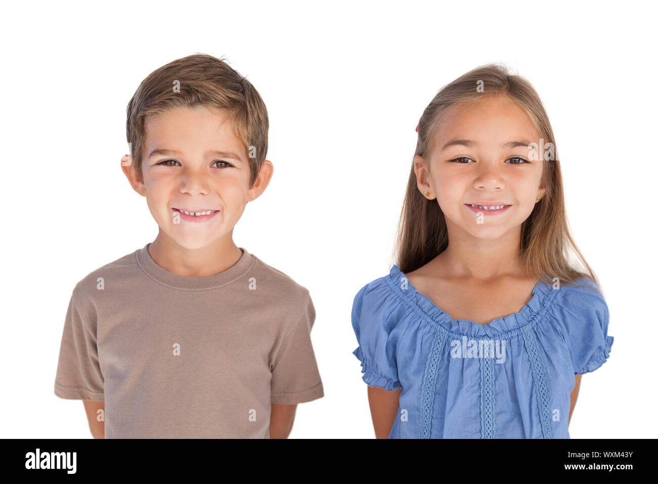 Two children standing and smiling at camera on white background Stock ...