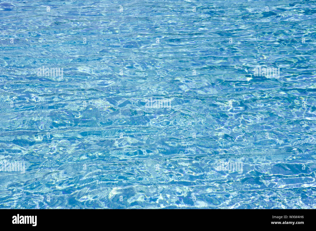 Blue pool water with sun reflections Stock Photo - Alamy