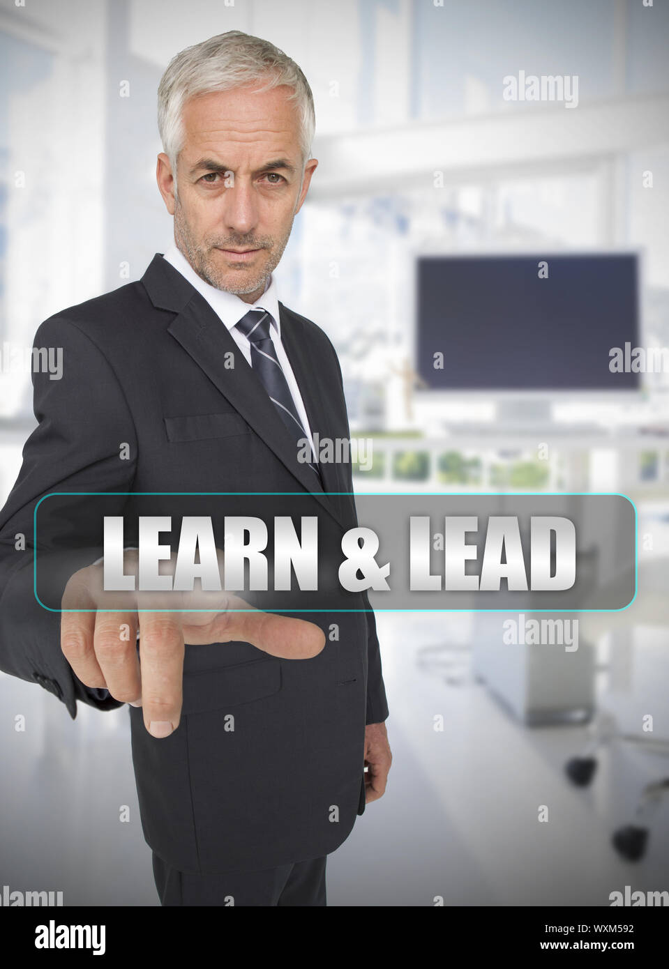 Businessman touching the term learn and lead in his office Stock Photo ...