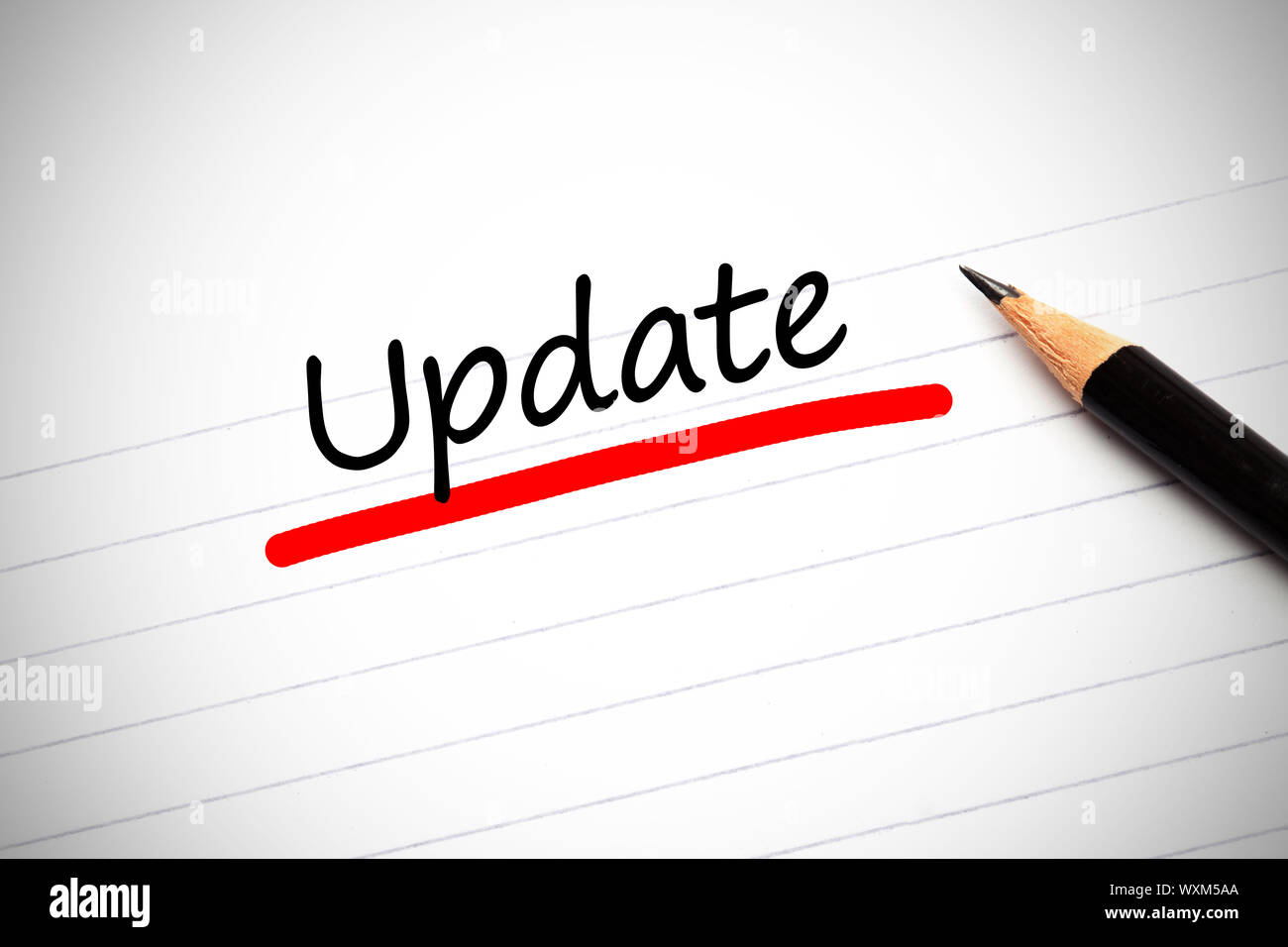 The word update written on a notepad with a pencil and underlined in ...
