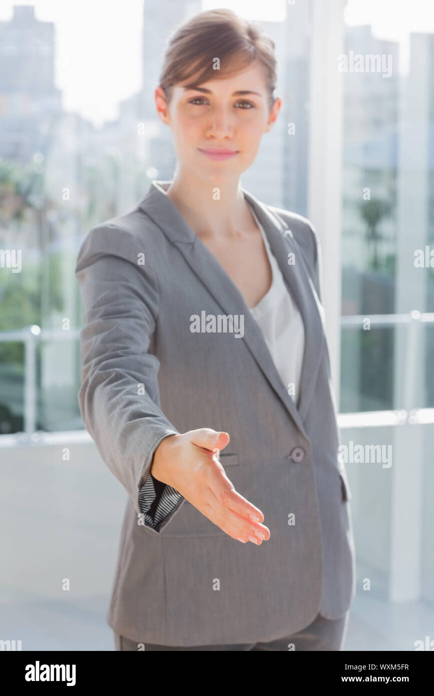 Businesswoman reaching out greeting handshake hi-res stock photography ...