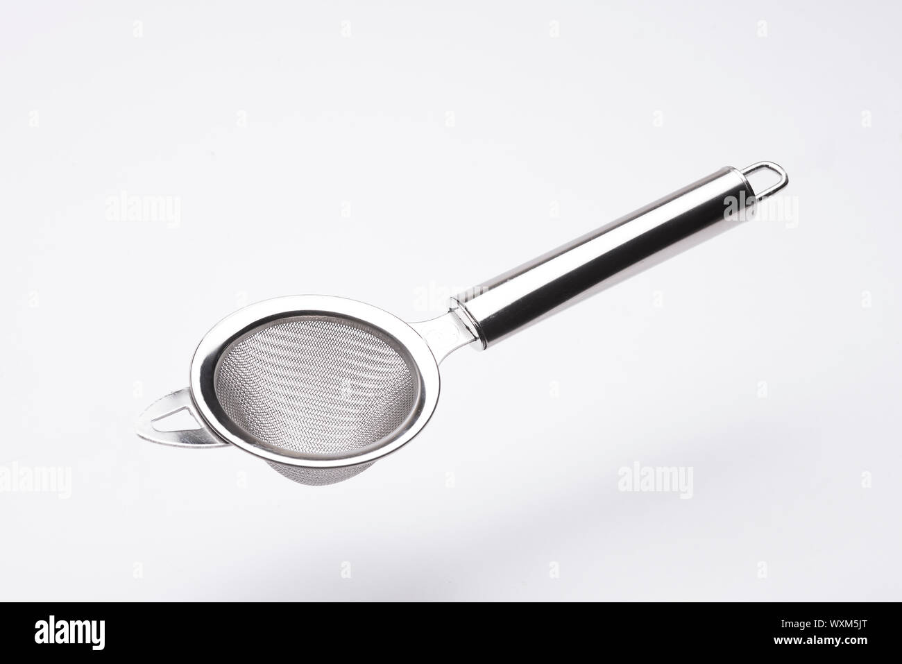 Stainless steel strainer in white background Stock Photo - Alamy