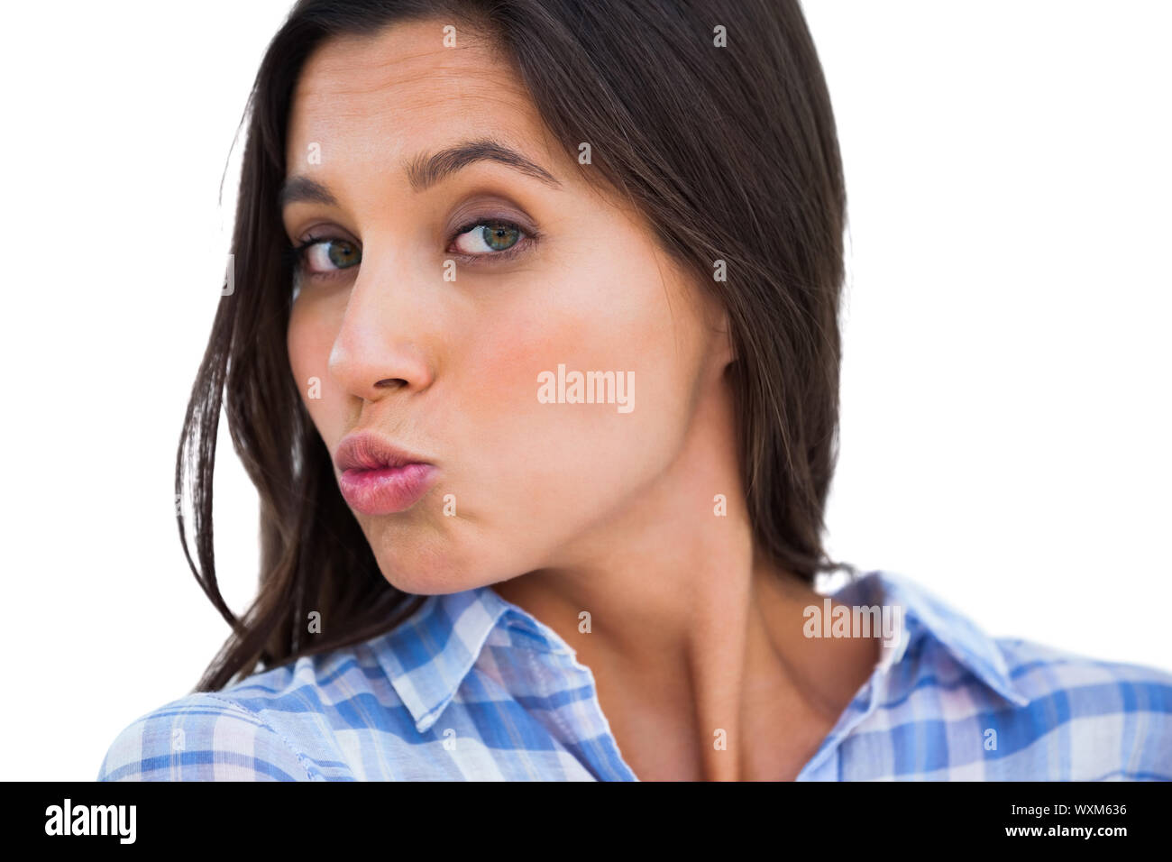 Brunette making kissing face at camera on white background Stock Photo ...