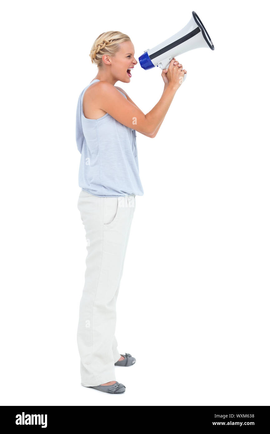 Blonde woman shouting through megaphone on white background Stock Photo ...