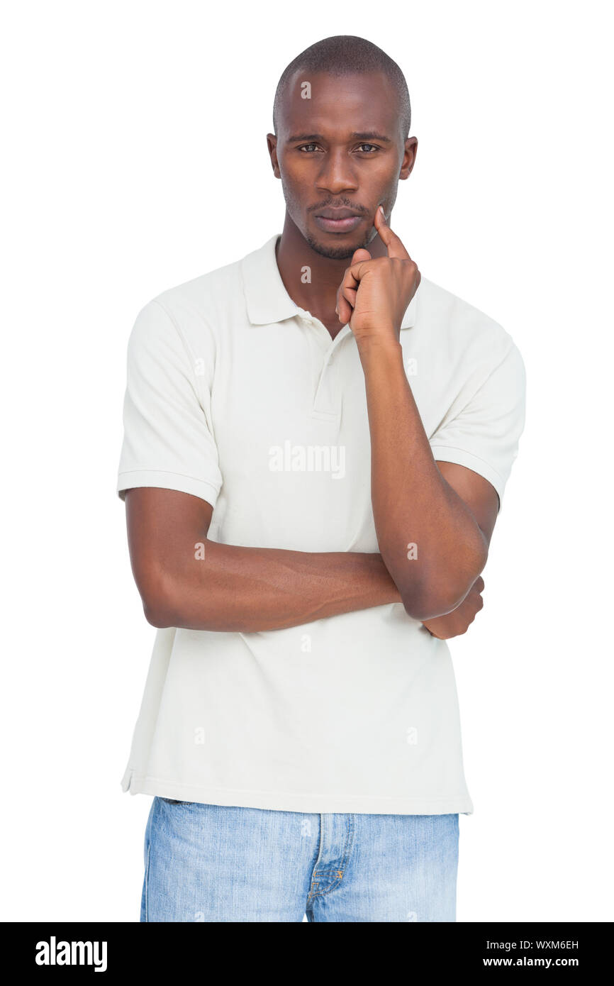 Serious man thinking with hand on chin on a white background Stock ...