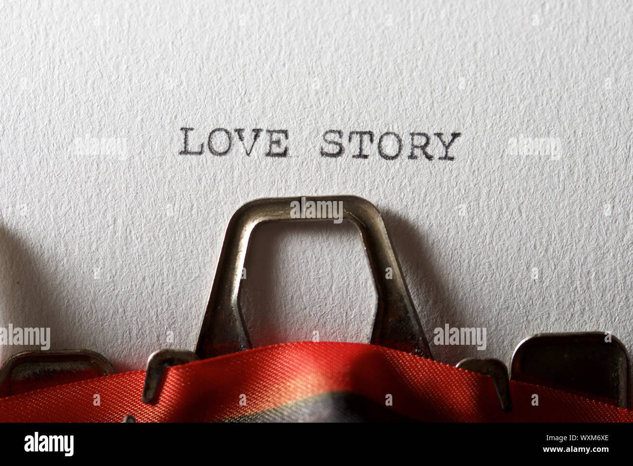 The sentence, Love Story, written with a typewriter Stock Photo - Alamy