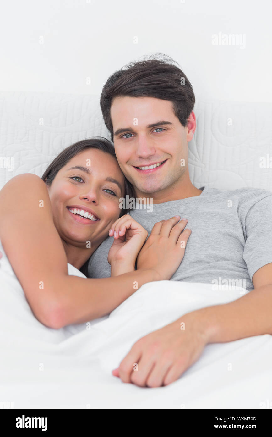 Pretty woman embracing her partner in bed in the bedroom Stock Photo ...