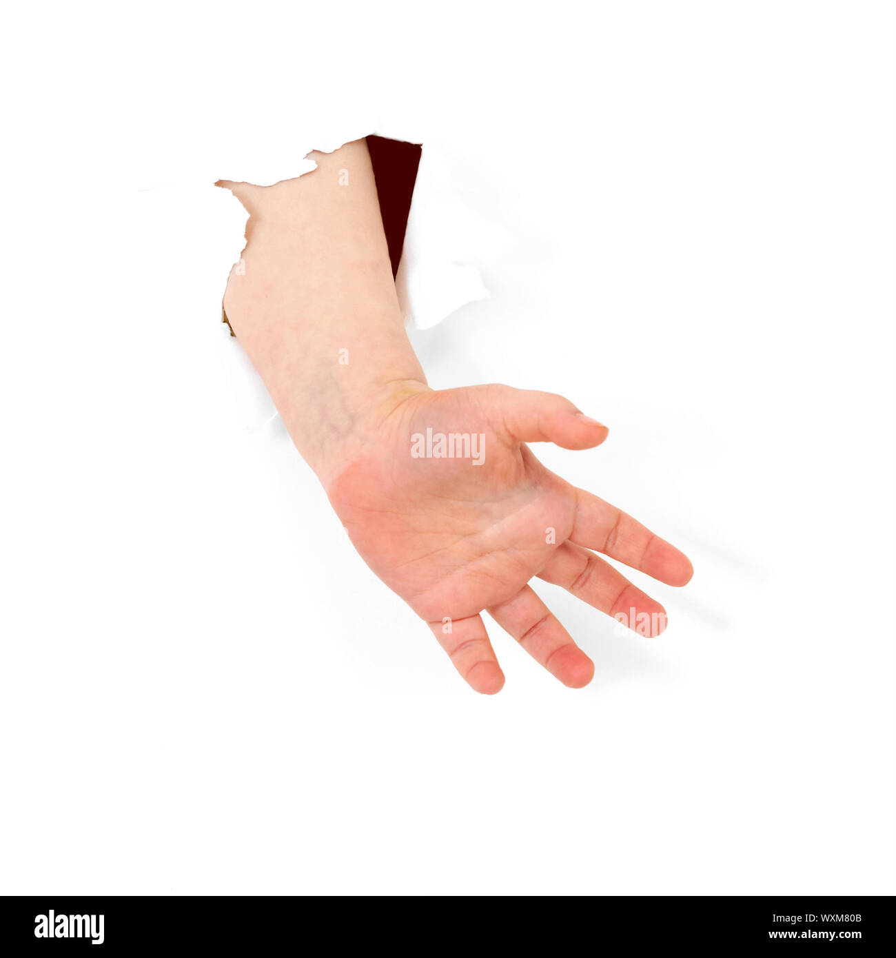 Child's hand stick out from hole in sheet of paper Stock Photo - Alamy