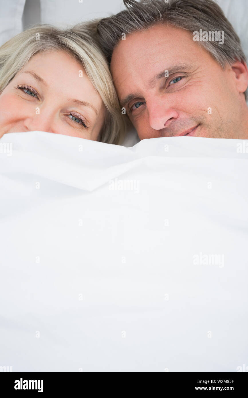Man looking under covers bed hi-res stock photography and images - Alamy