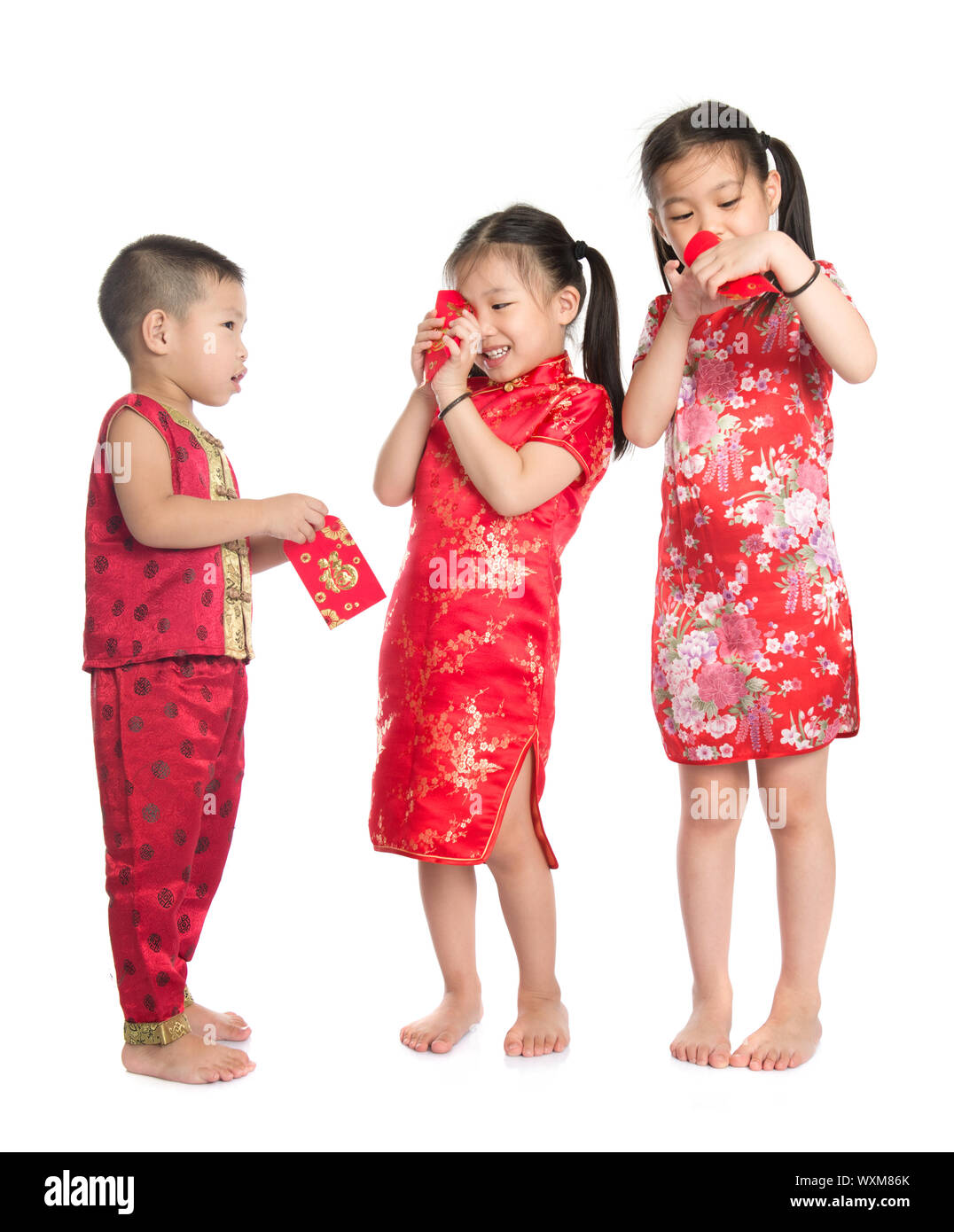 Asian children peeking into red packet during Chinese New Year, with ...