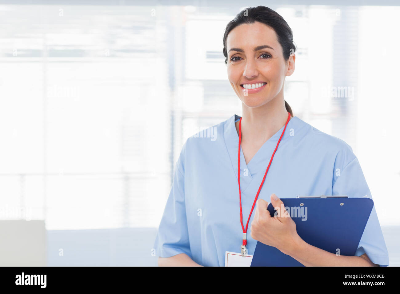 Nurse holding files in medical office Stock Photo - Alamy