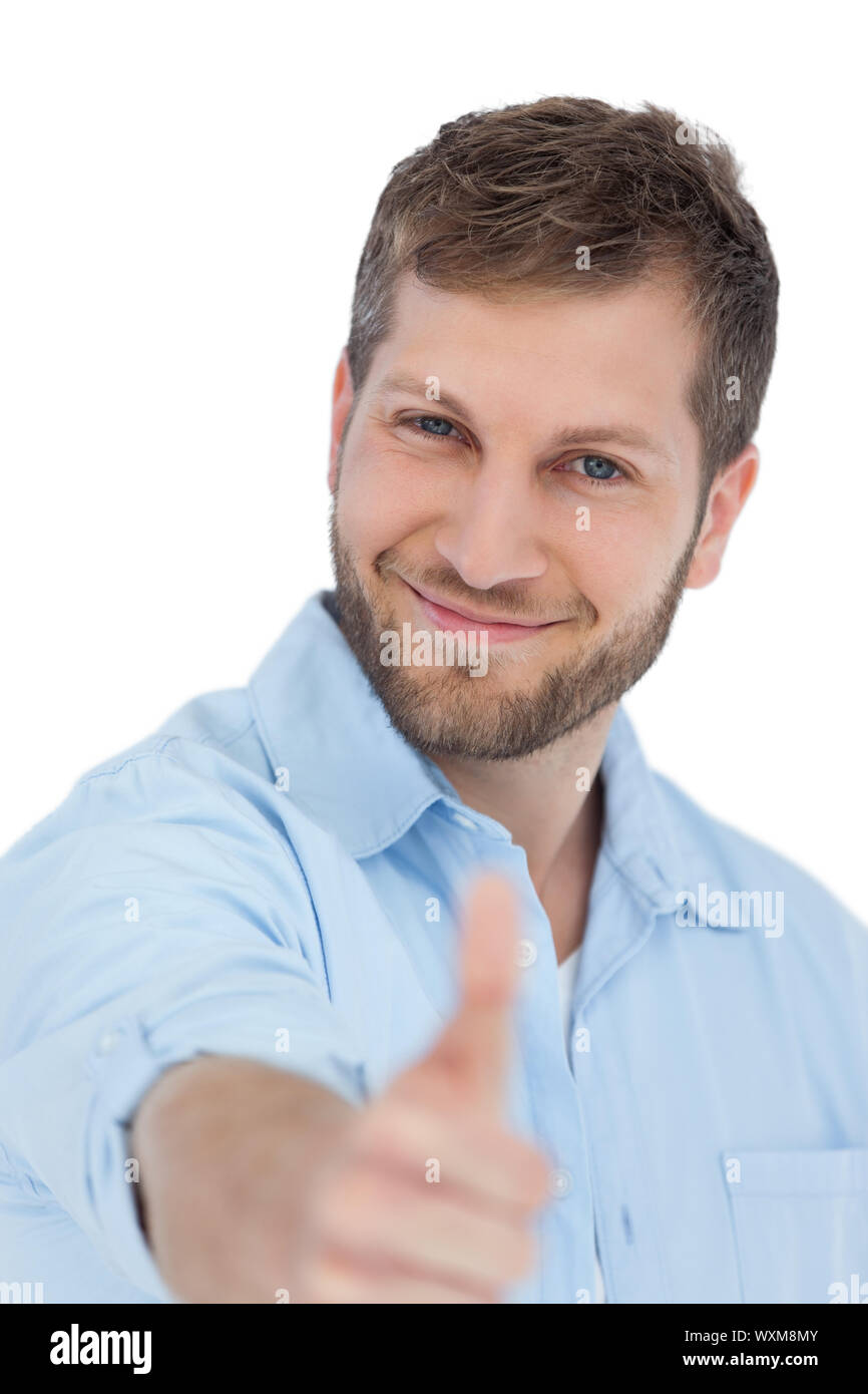 Enthusiastic young model posing with thumbs up on white background ...
