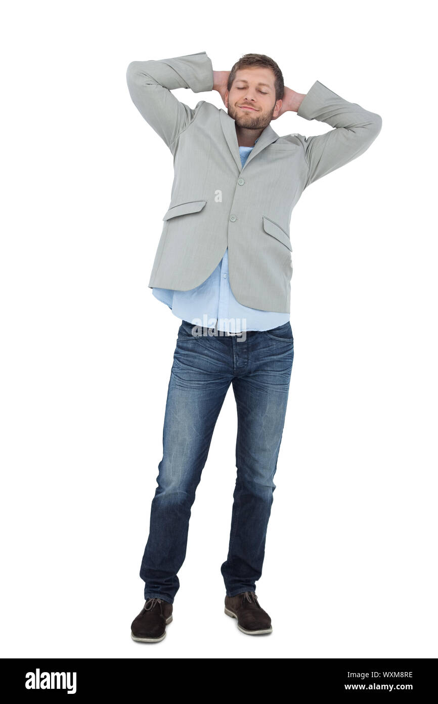 Suave man in a blazer with hands behind head on white background Stock ...