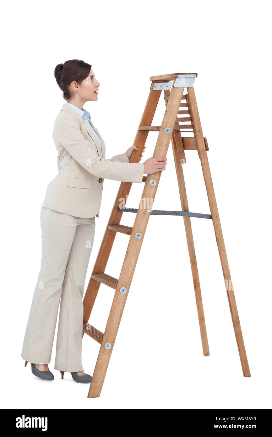 Cheerful businesswoman looking up the career ladder on white background ...