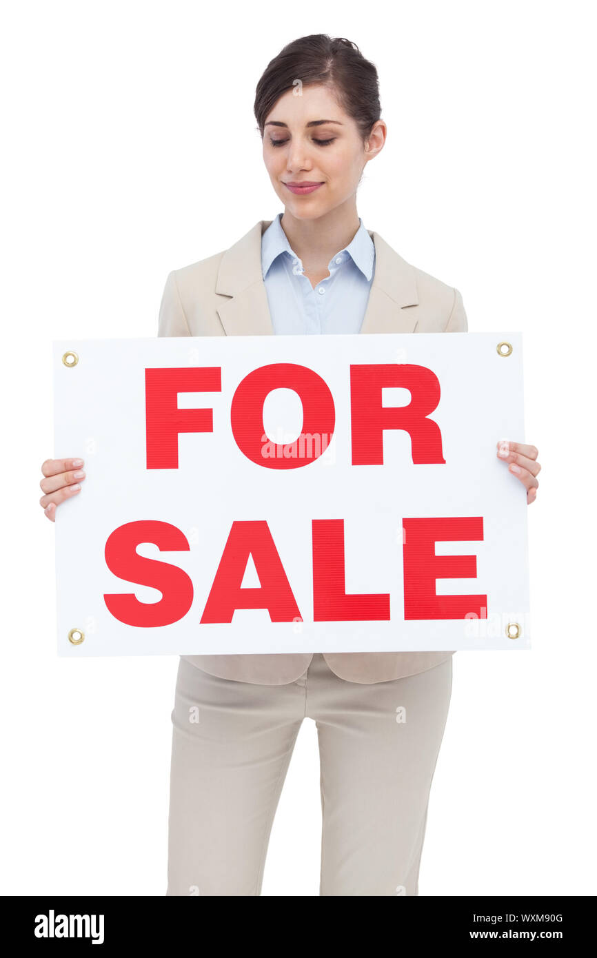 Estate agent holding for sale sign on white background Stock Photo - Alamy