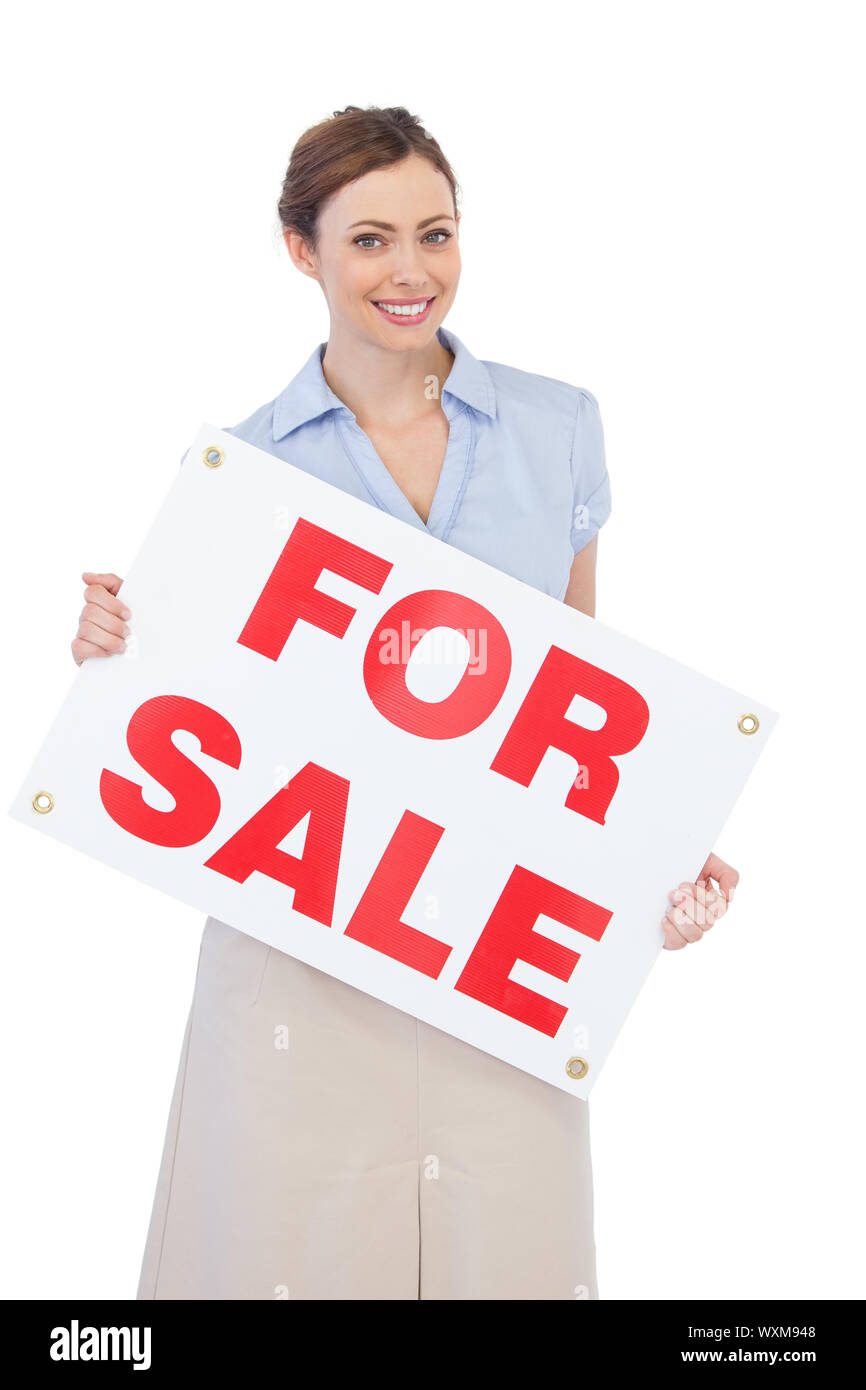 Estate agent posing with for sale sign against white background Stock ...