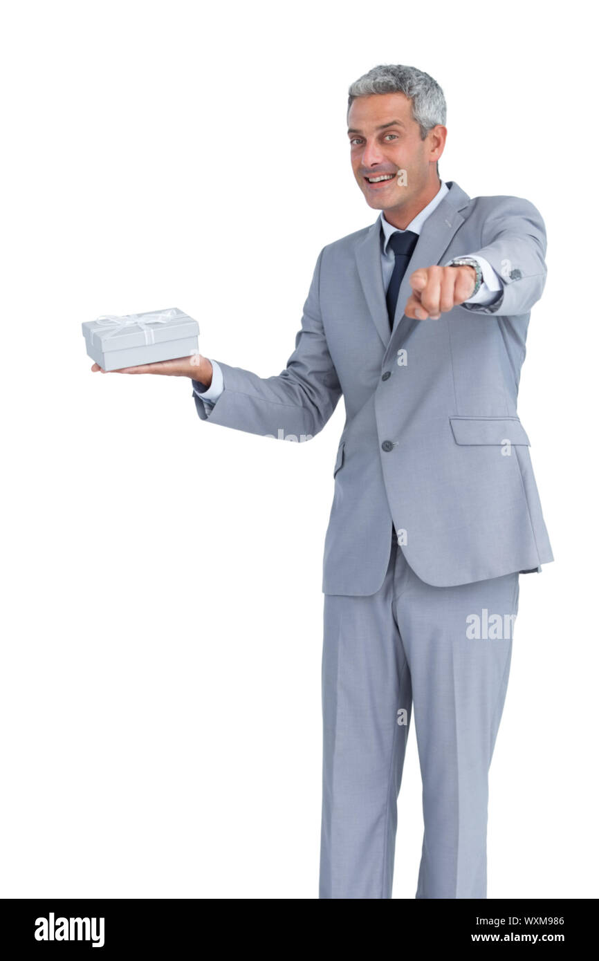 Good looking businessman against white background offering gift and ...