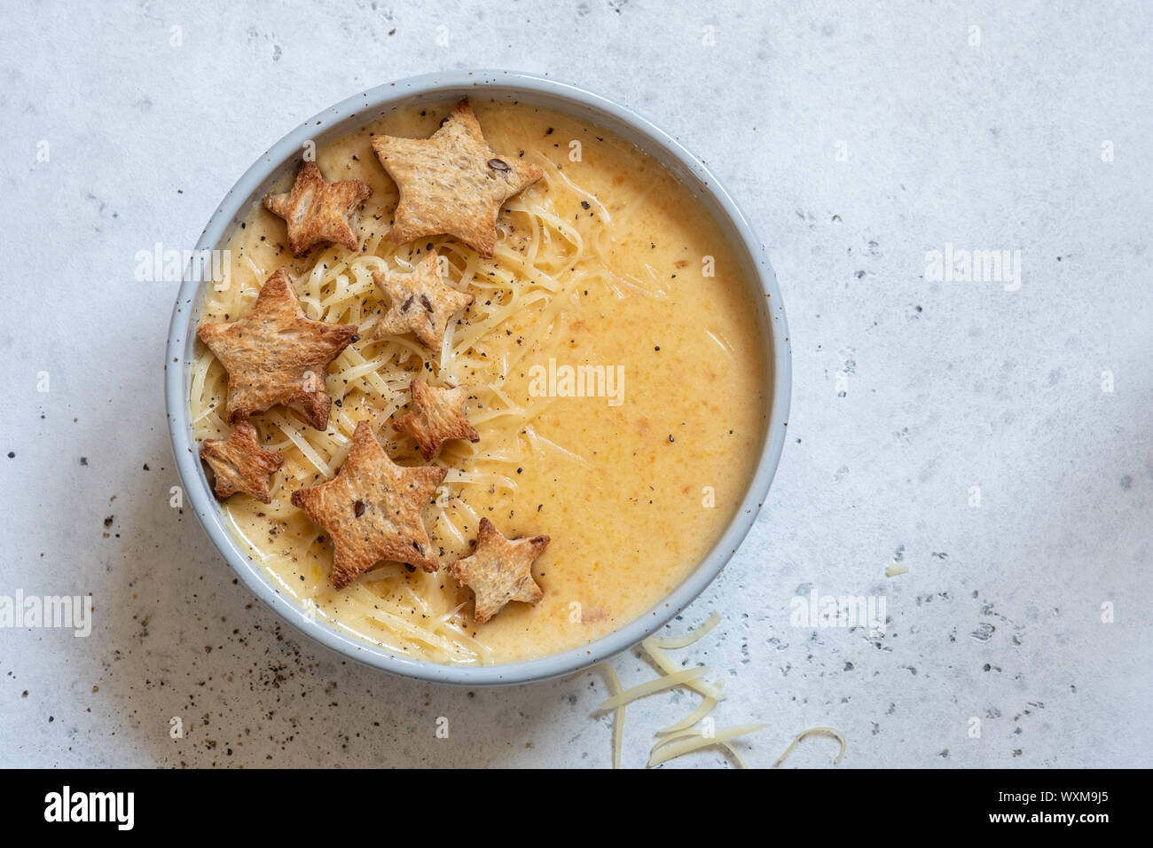 Cheese soup with star toasts on a table Stock Photo - Alamy