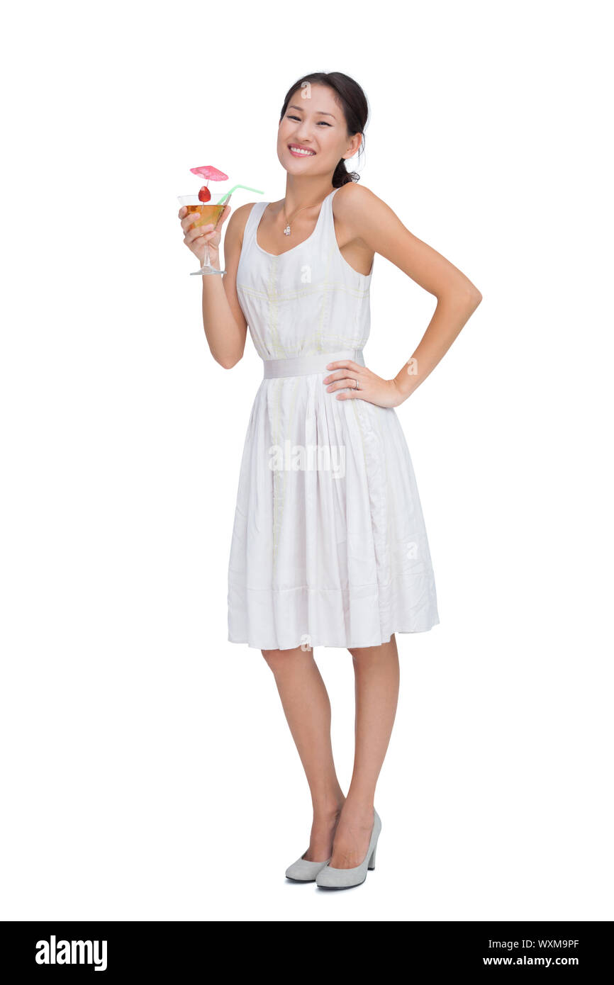 Cheerful brunette holding cocktail against white background Stock Photo ...