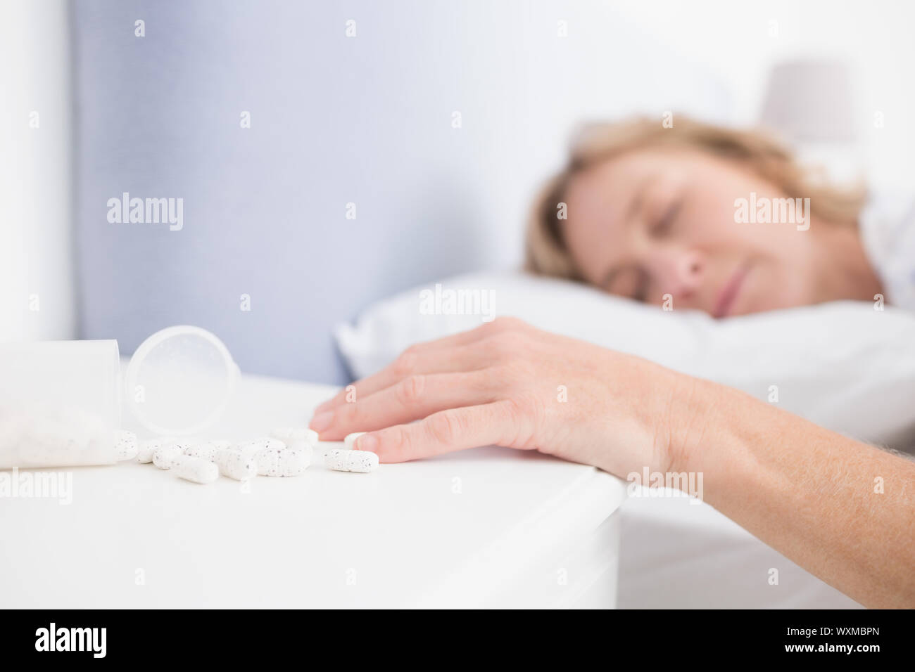 Blonde woman lying motionless after overdose of tablets at home in ...