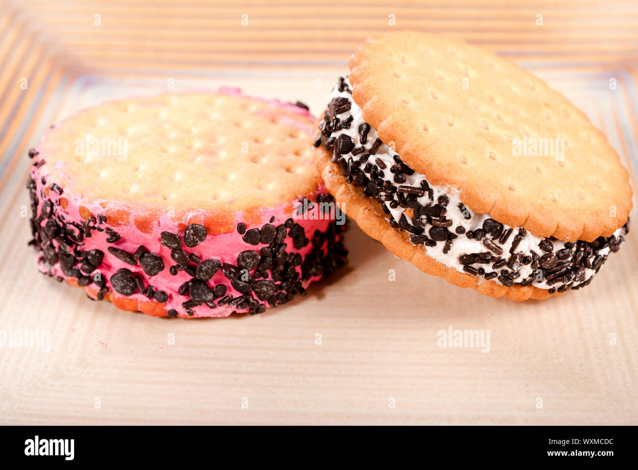 Two sweet biscuit cream cakes on the plate Stock Photo - Alamy
