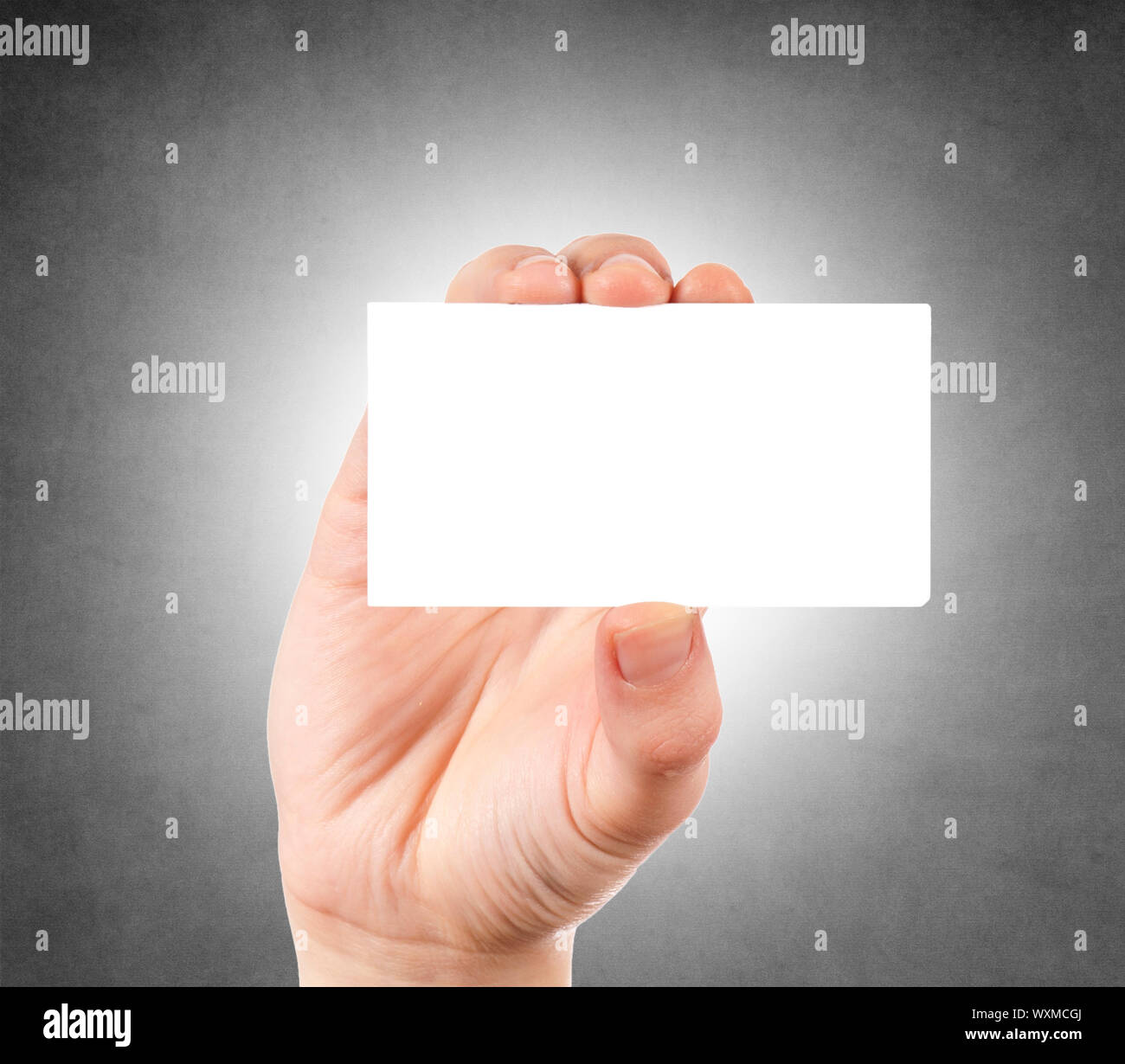 Blank calling card in the hand on dark gray background Stock Photo - Alamy