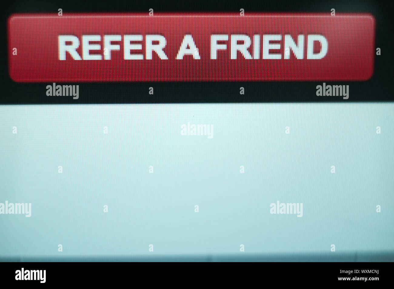 Close up Red button refer a friend on a white background Stock Photo ...