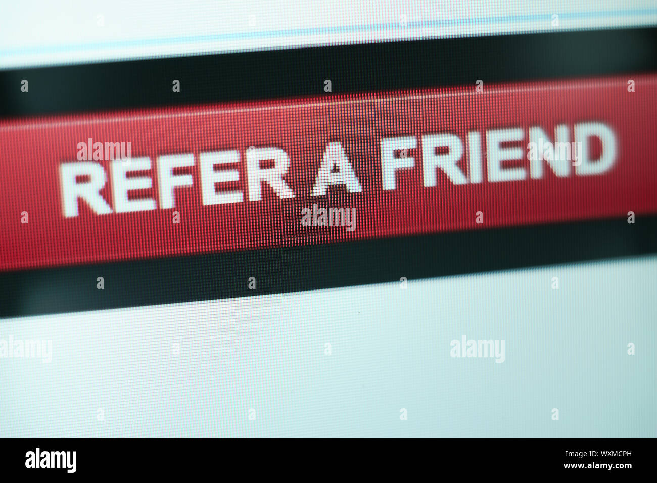 Close up Red button refer a friend on a white background Stock Photo ...