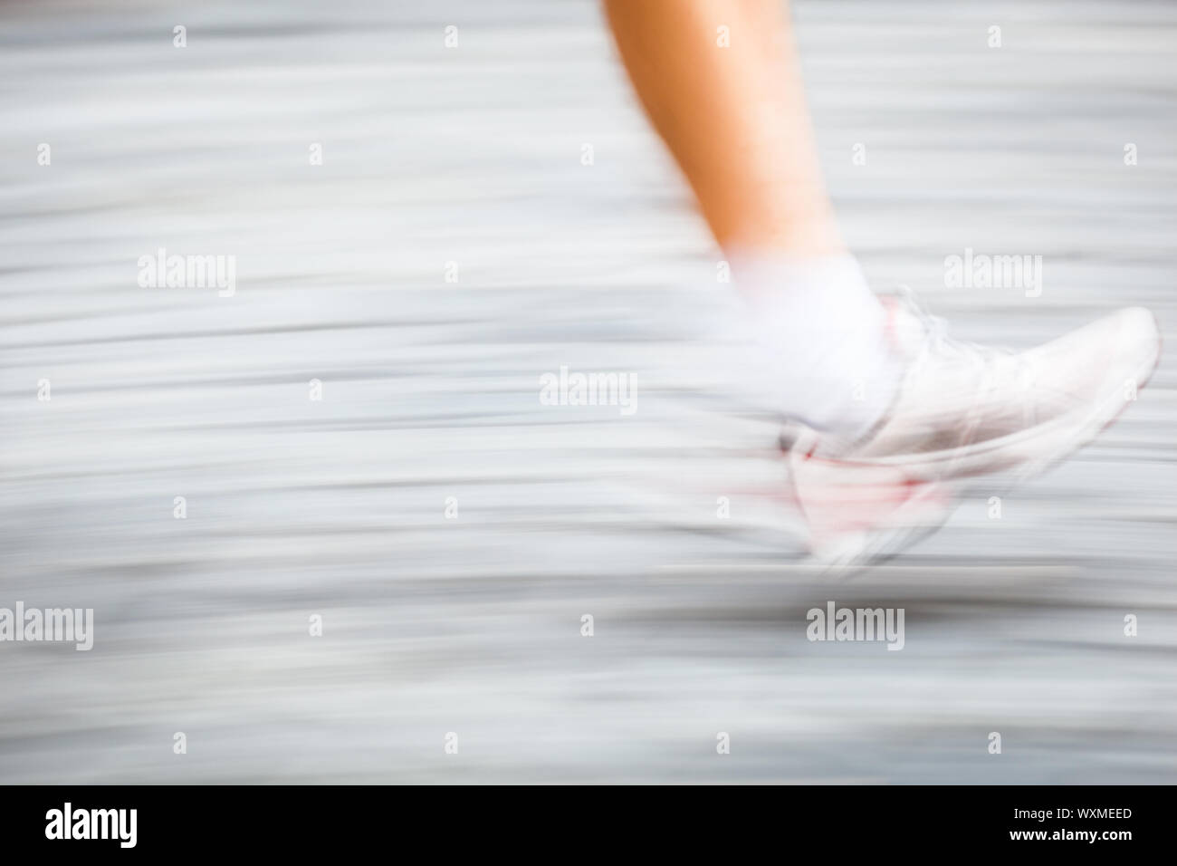 Motion blurred runner's feet in a city environment - running marathon ...