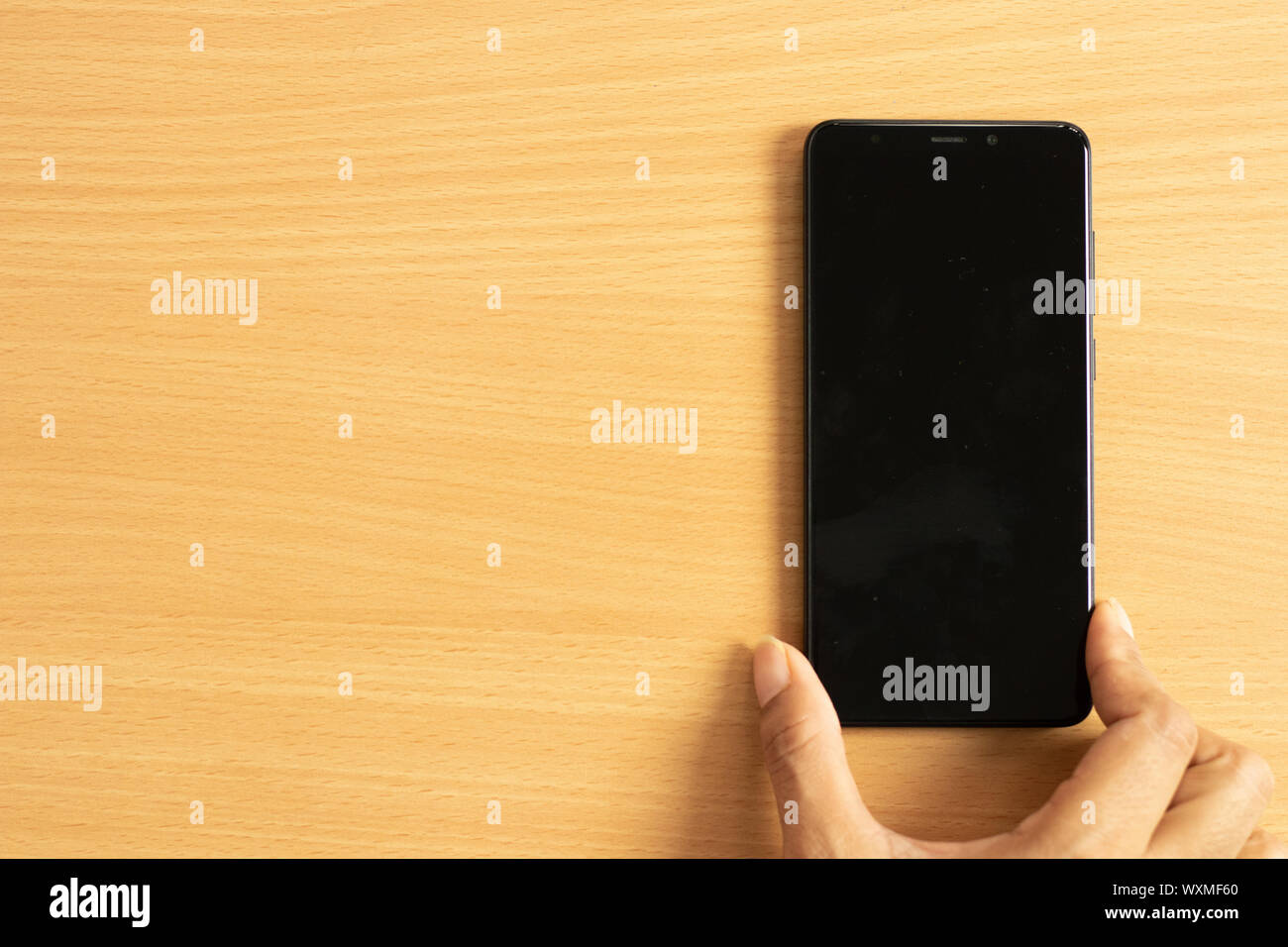 hand using phone light wood screen on top view Stock Photo - Alamy