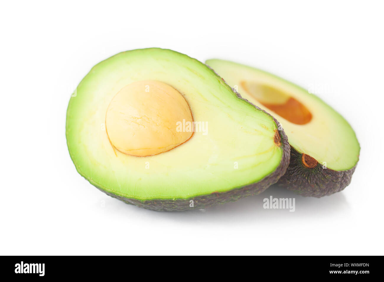 two halves of avocado isolated on white Stock Photo - Alamy