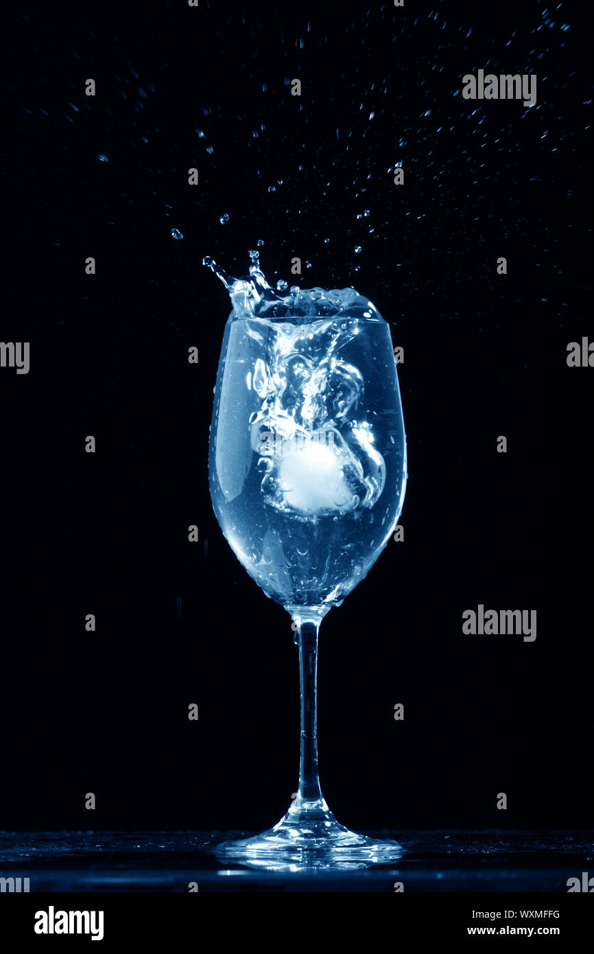 alcohol splash on black background Stock Photo - Alamy