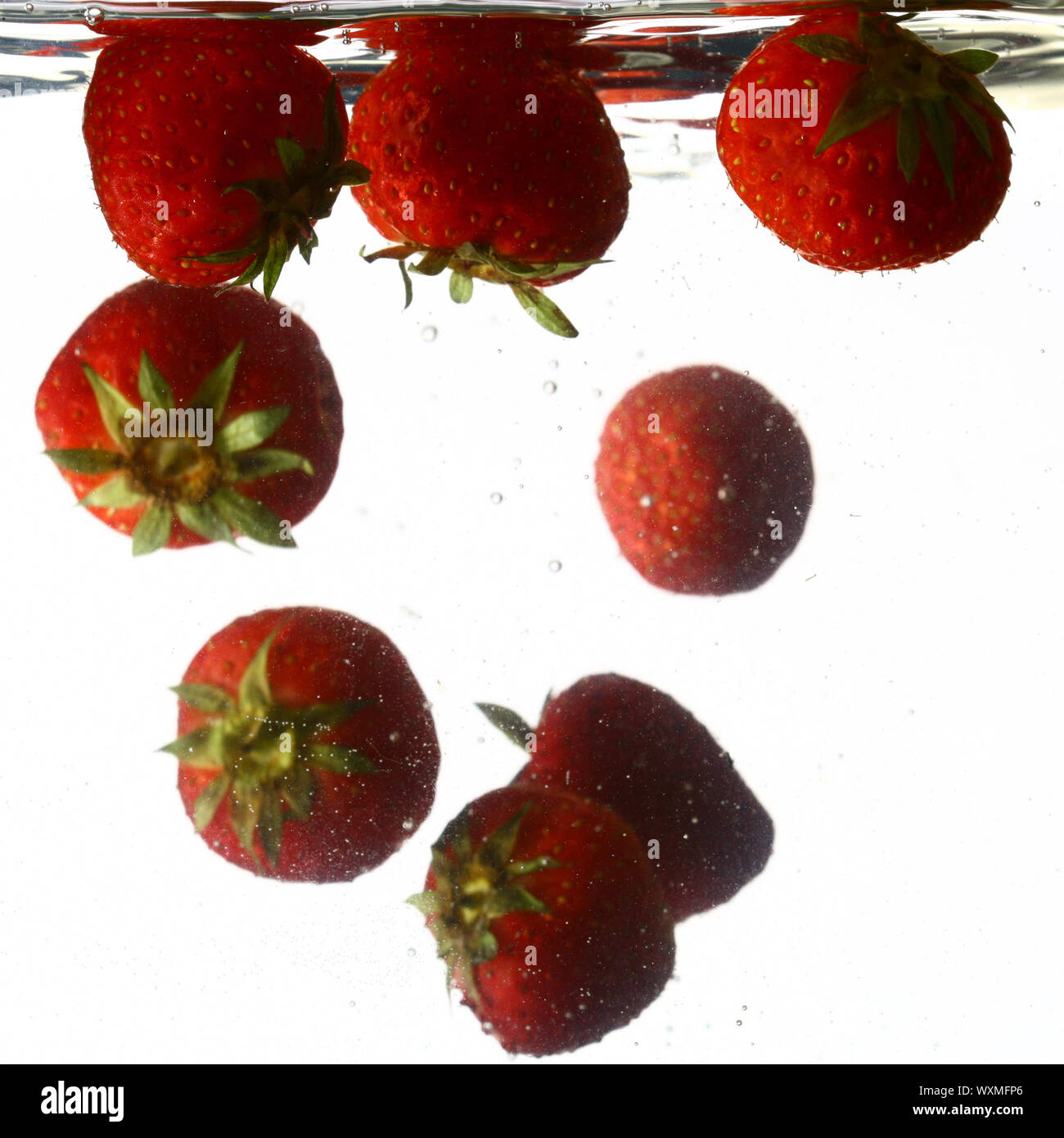 strawberry splash in water isolated on white background Stock Photo - Alamy